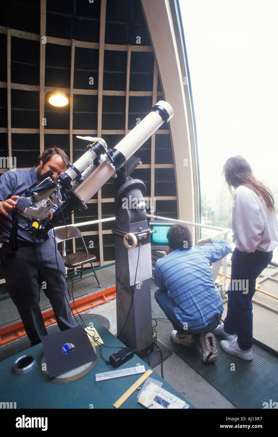 Astronomers using a telescope at Griffith Park Observatory Los Angeles ...