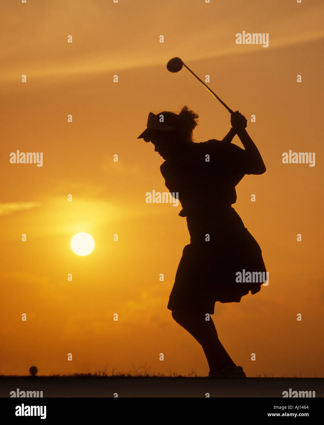 Woman swinging golf club hi-res stock photography and images - Alamy