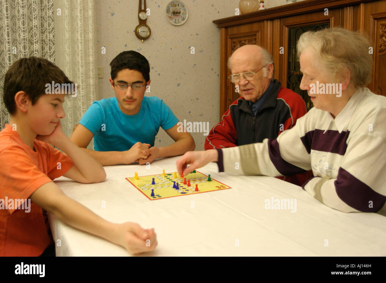 grandparents and their grandsons are playing a board game Stock Photo ...