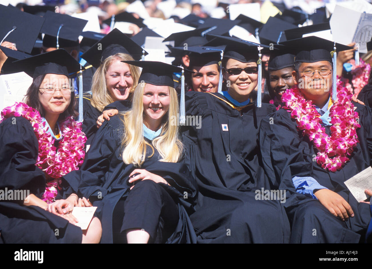 Graduates march across the stadium field at the University of ...