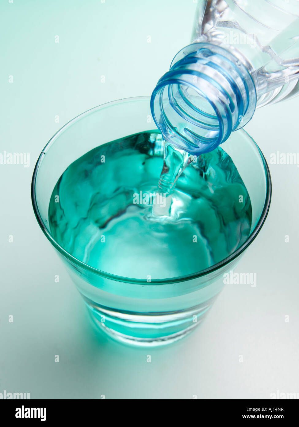A bottle pouring mineral water into a glass Stock Photo - Alamy
