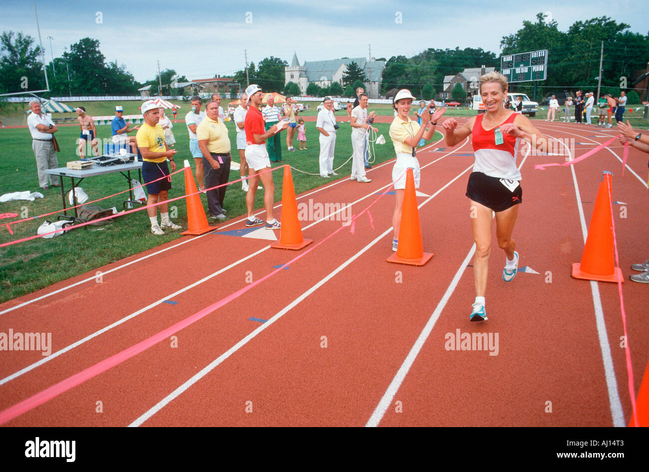 A female runner crossing the finish line at the Senior Olympics St ...