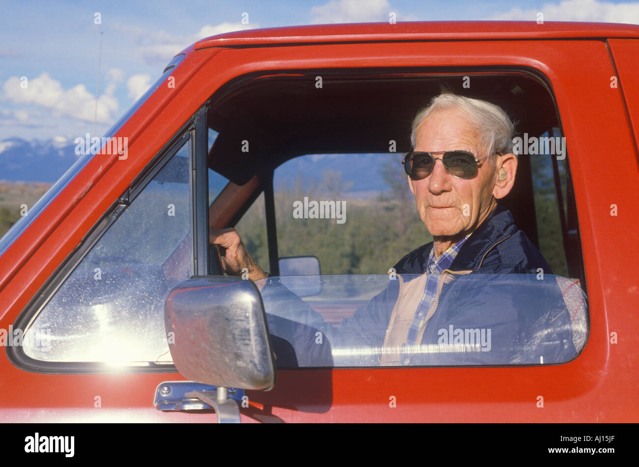 A senior citizen in a red pickup truck National Bison Range MT Stock ...