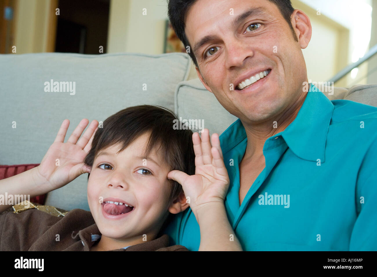 Portrait of a young boy making silly faces with his father Stock Photo ...