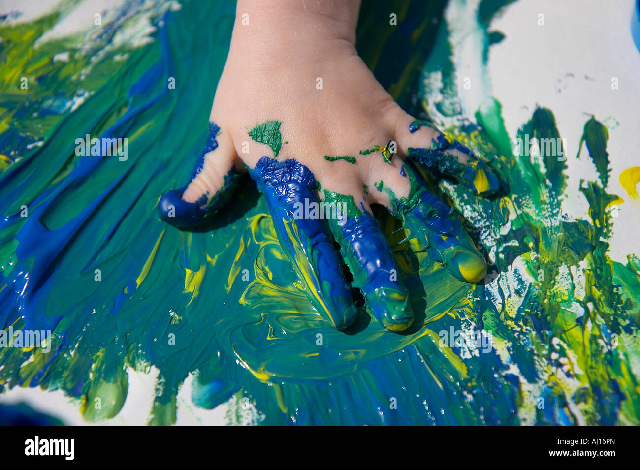 little boy painting with finger colours Stock Photo - Alamy