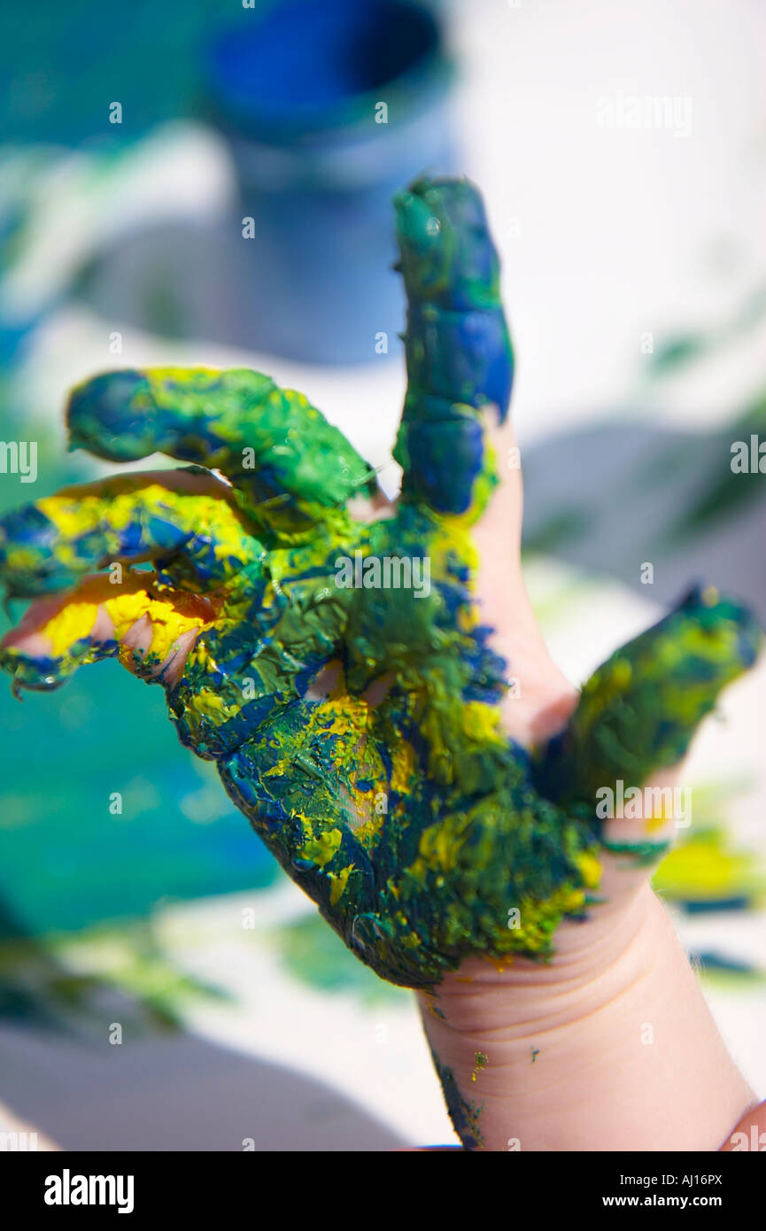 little boy painting with finger colours Stock Photo - Alamy