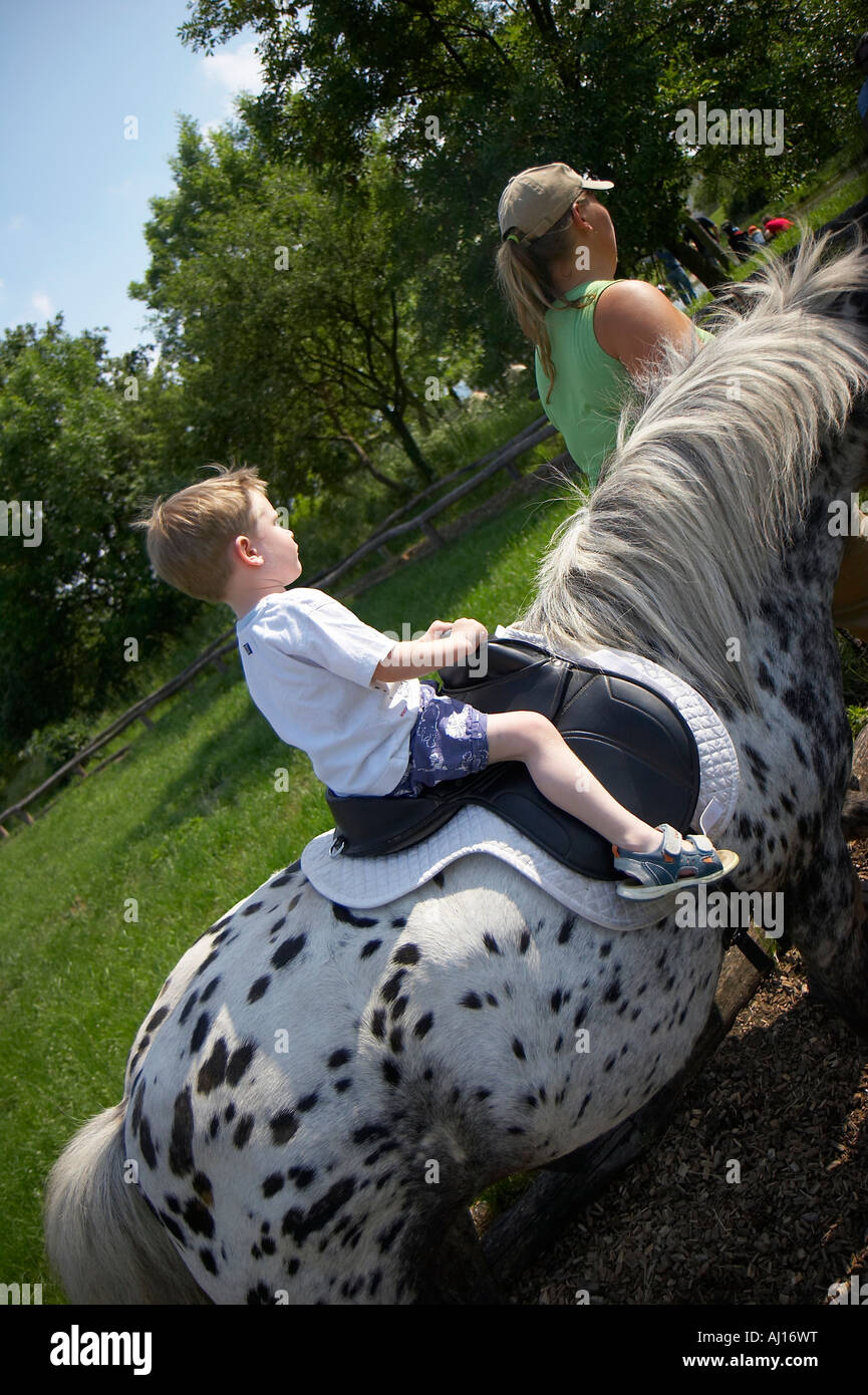 Baby boy riding pony hi-res stock photography and images - Alamy