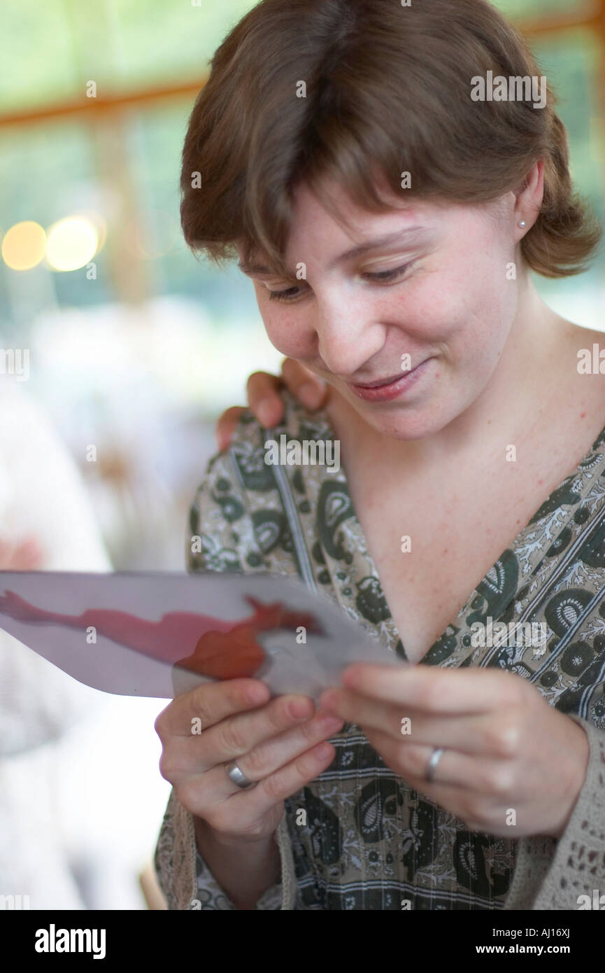 young woman reading present card Stock Photo - Alamy