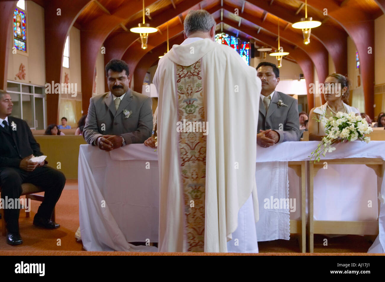 Catholic Priest Administers Wedding Vows To Two Latino American Couples