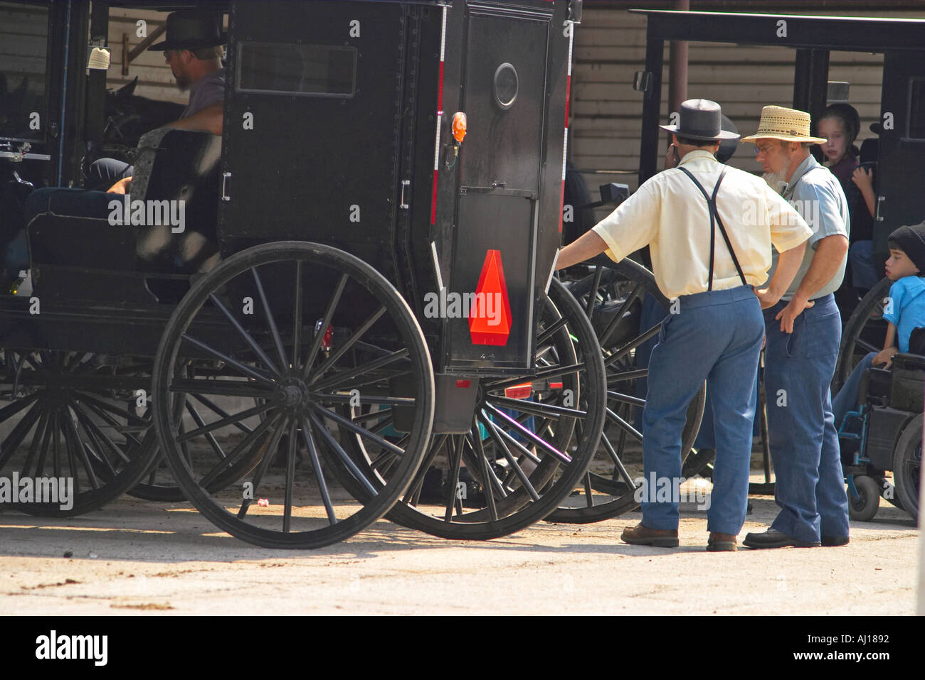 ILLINOIS Arthur Amish men talk standing by horse drawn buggies in ...