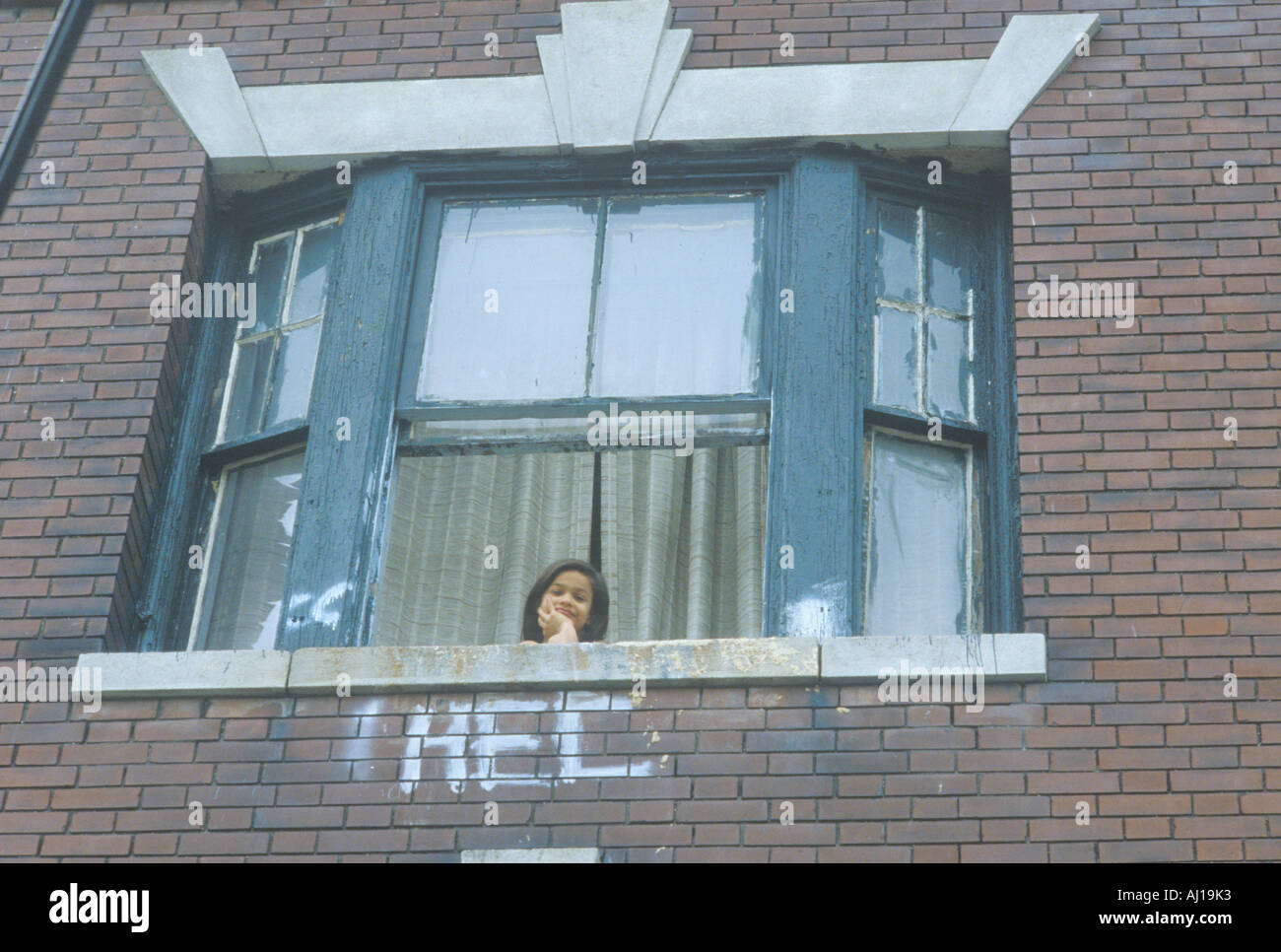 A child looking out of her apartment window South Bronx NY Stock Photo ...