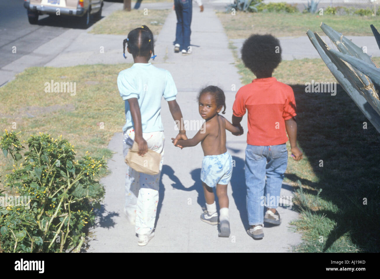 Three African American children walking home South Central Los Angeles ...