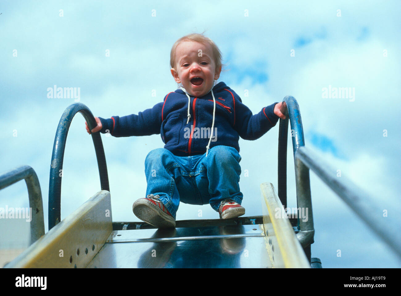 A child coming down a slide Stock Photo - Alamy