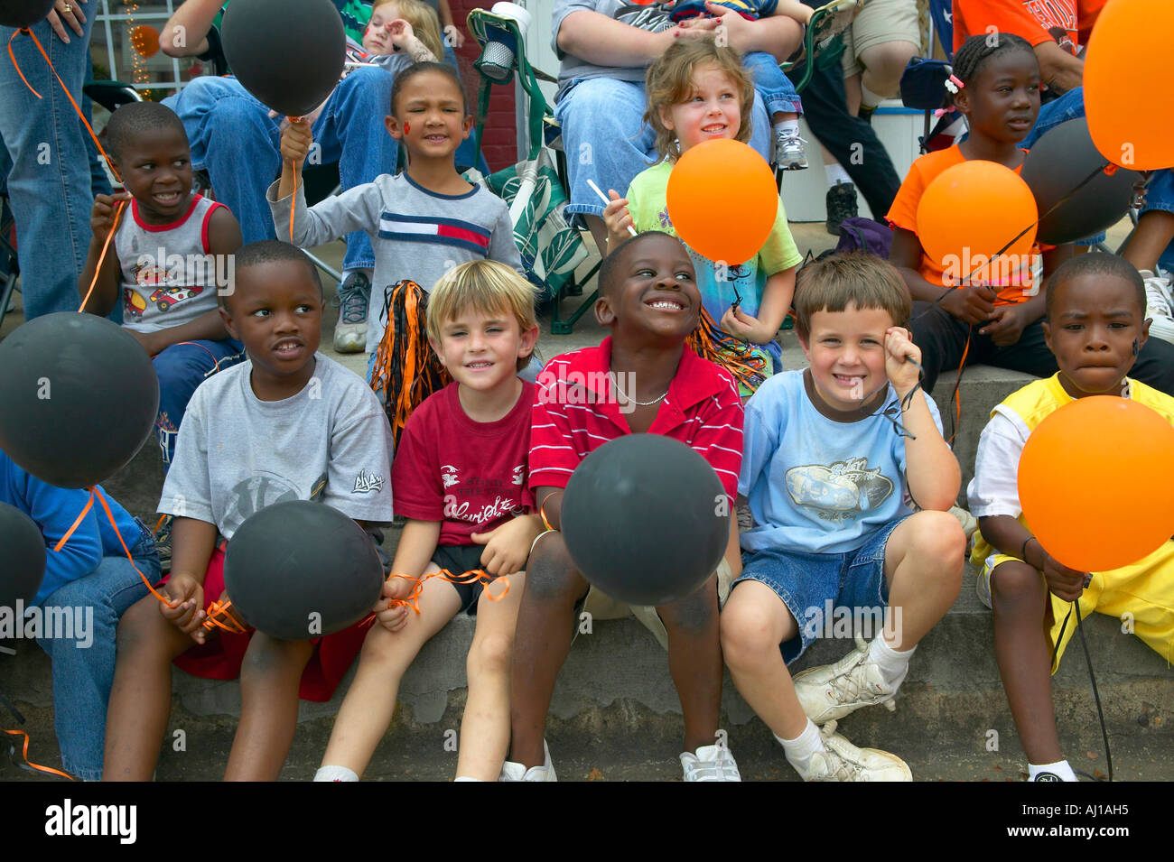 Children smiling and holding balloons at parade in Central GA Stock ...