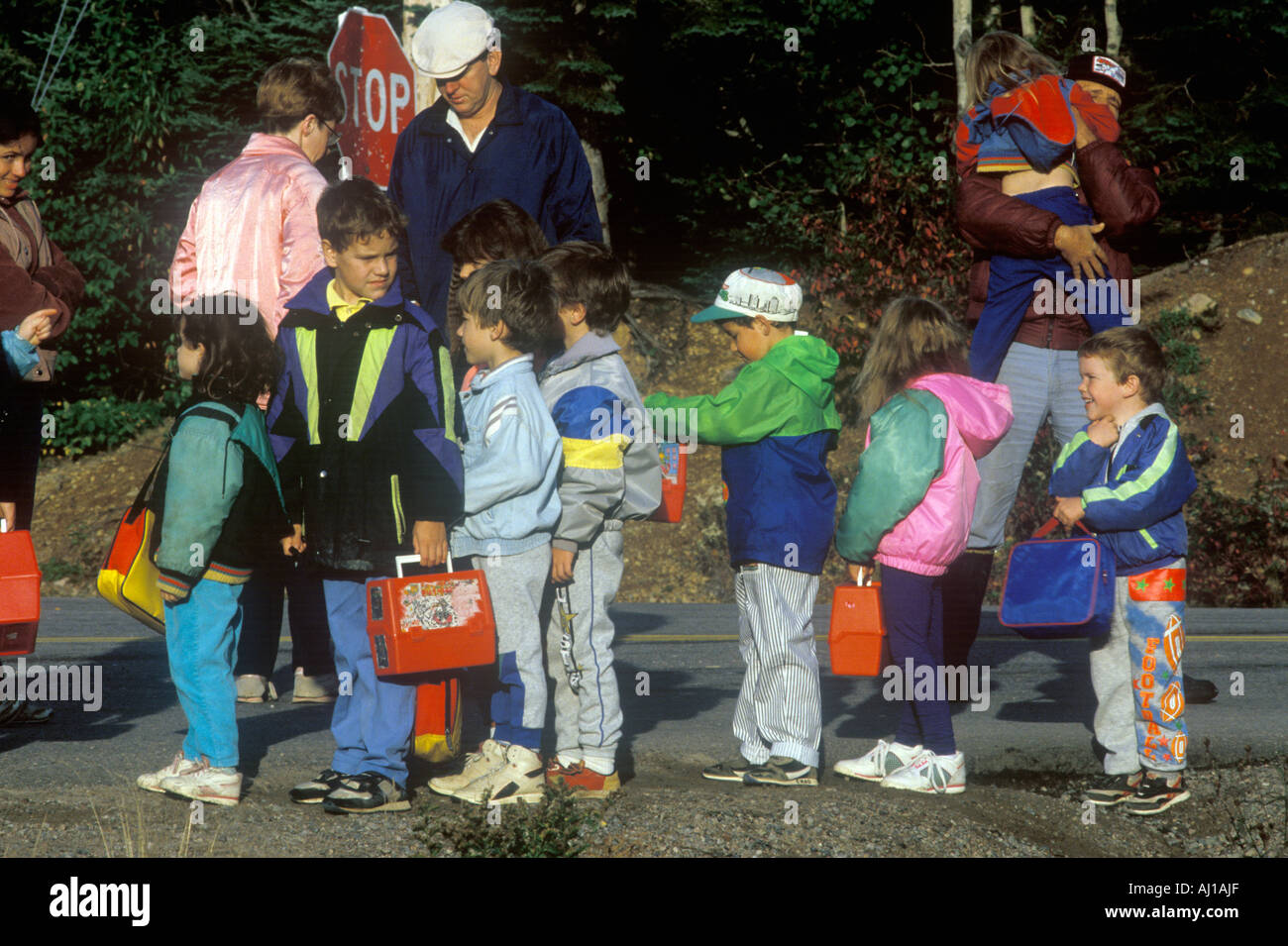 young children waiting to board school bus Stock Photo - Alamy