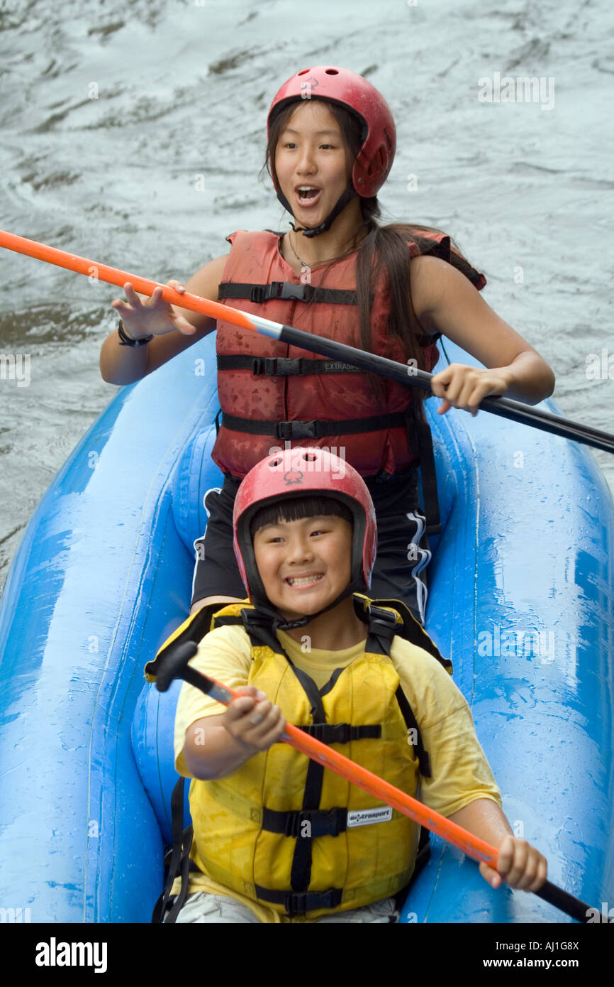 Girls rafting down whitewater river Stock Photo - Alamy