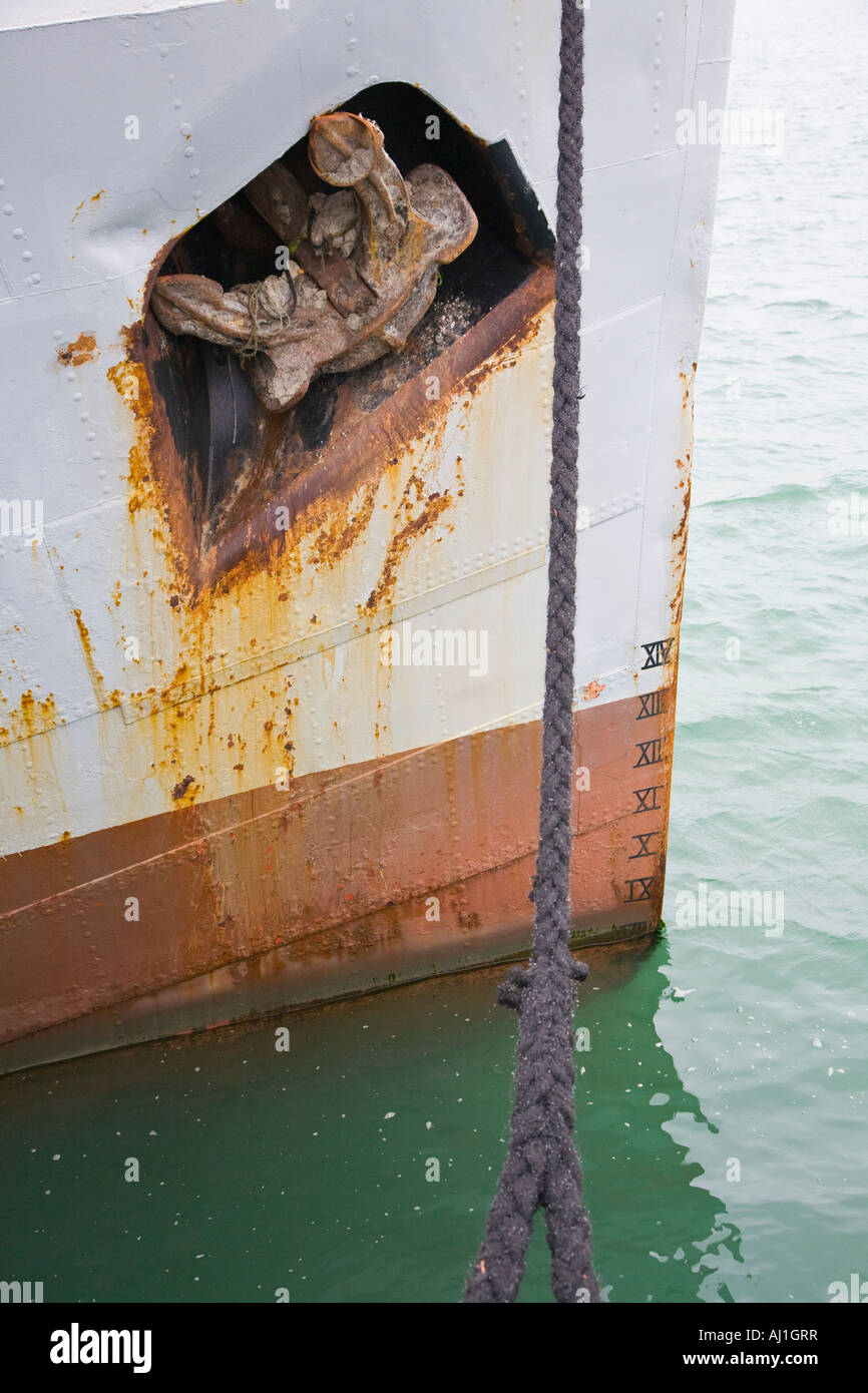 Mud encrusted anchor stored in recess at front of the hull Stock Photo ...