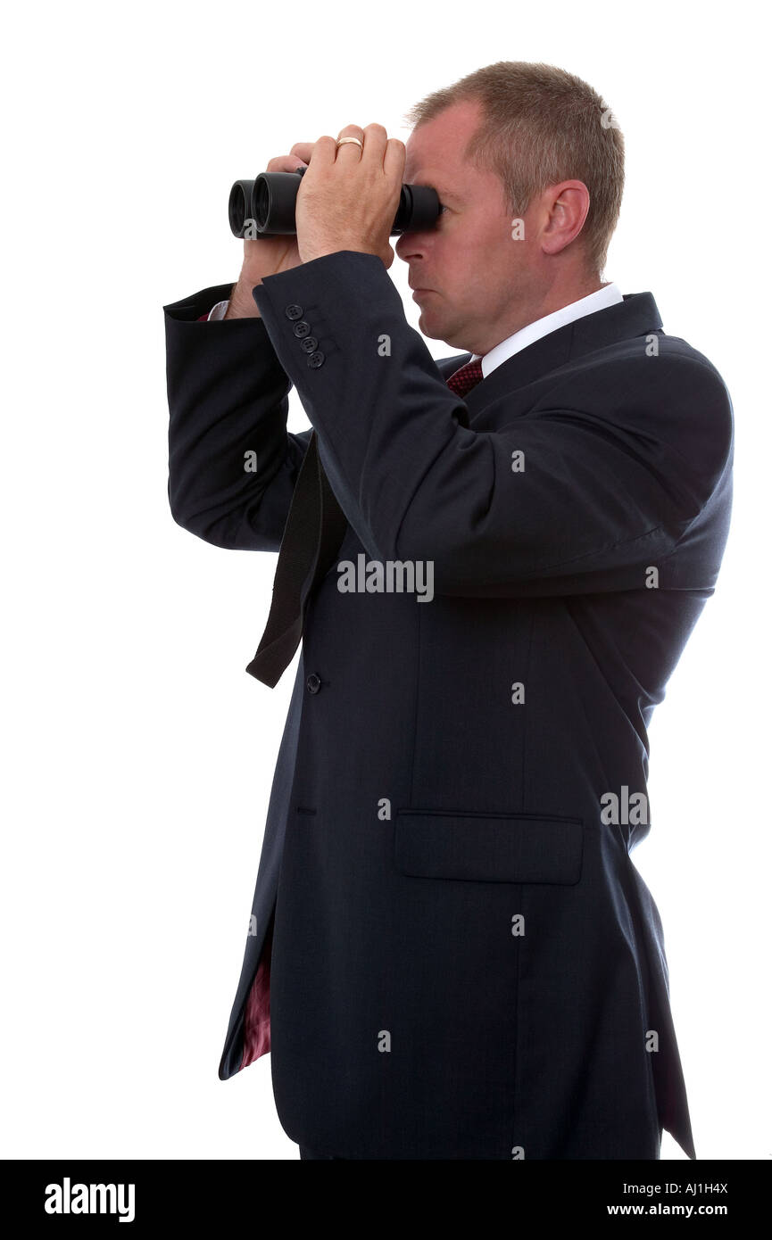 Businessman on the lookout for something using a pair of binoculars ...