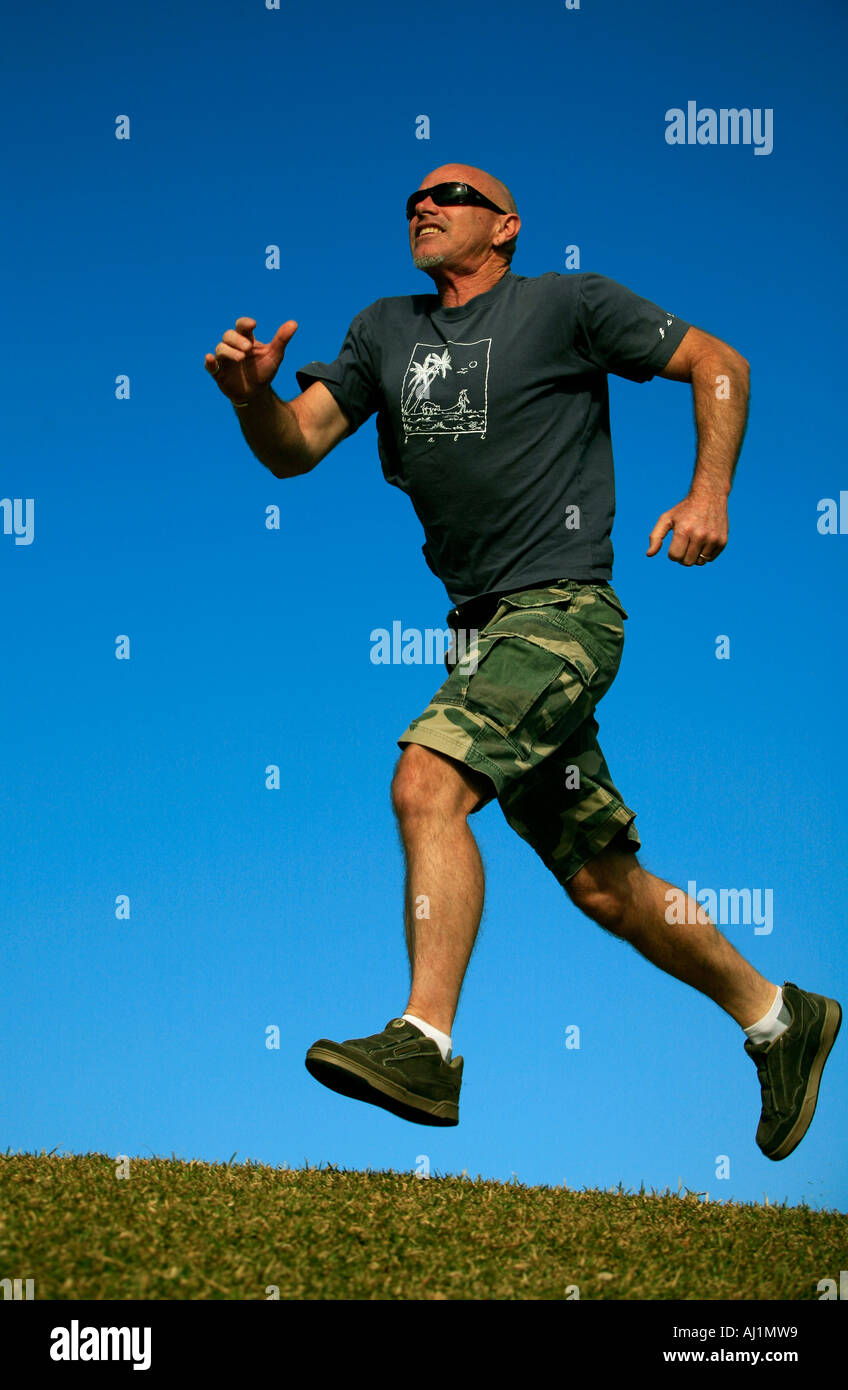 Man in blue shorts runs hi-res stock photography and images - Alamy