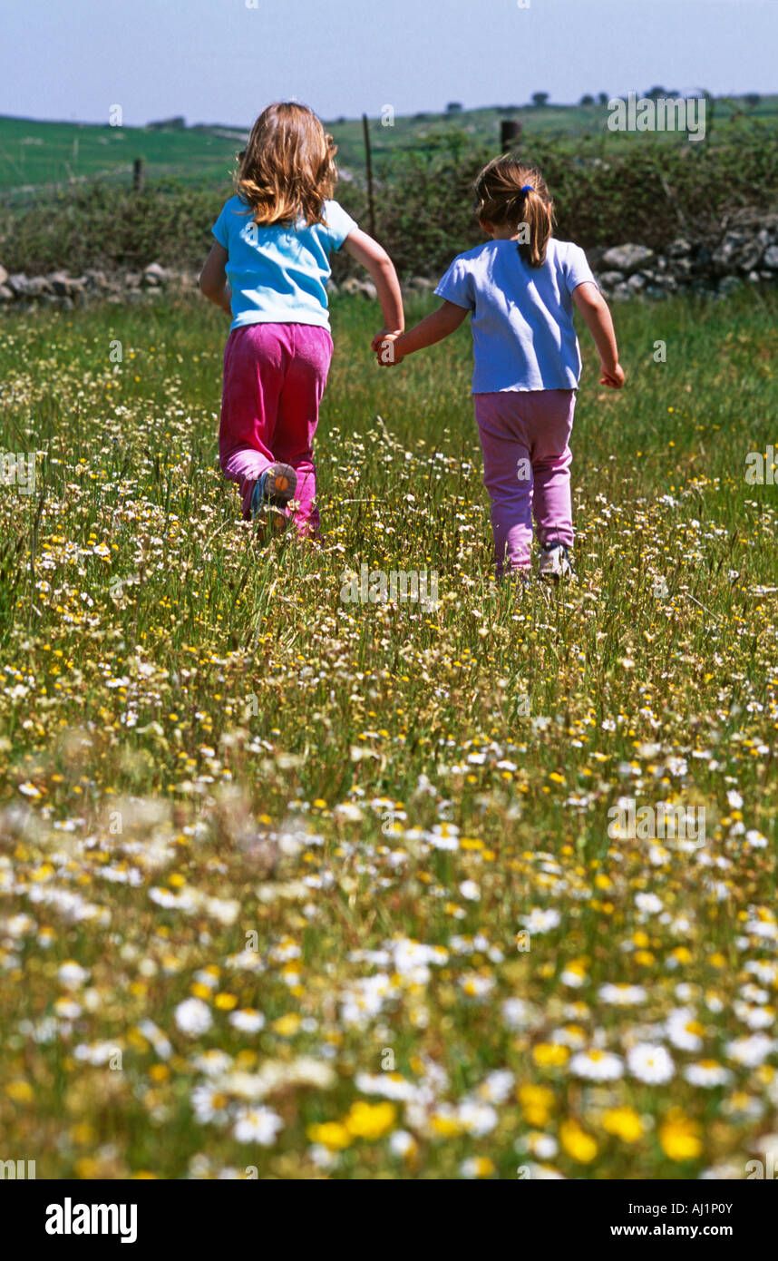 Young girls in field Stock Photo - Alamy