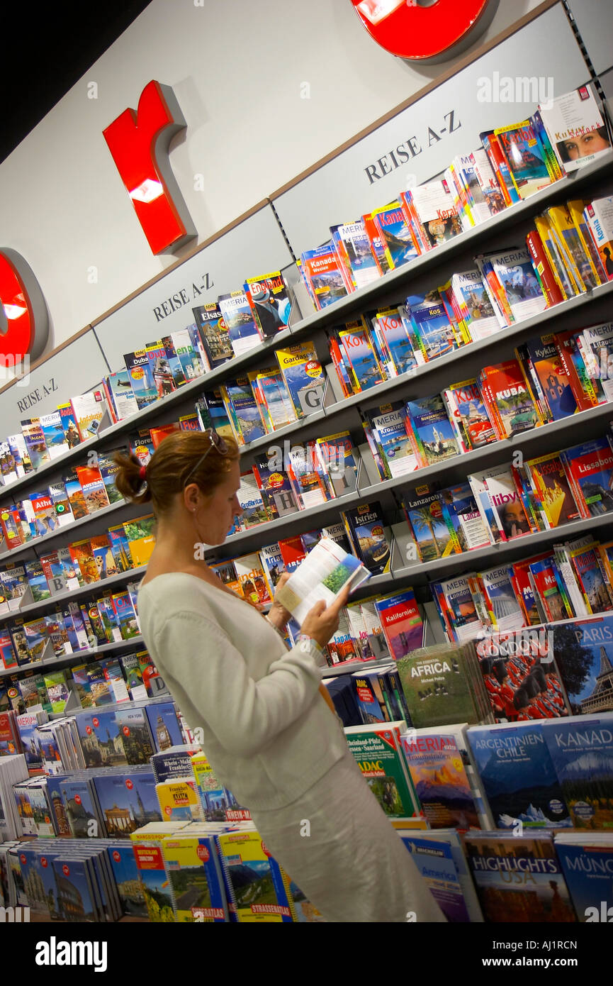 woman reading a book in the book shop Stock Photo - Alamy