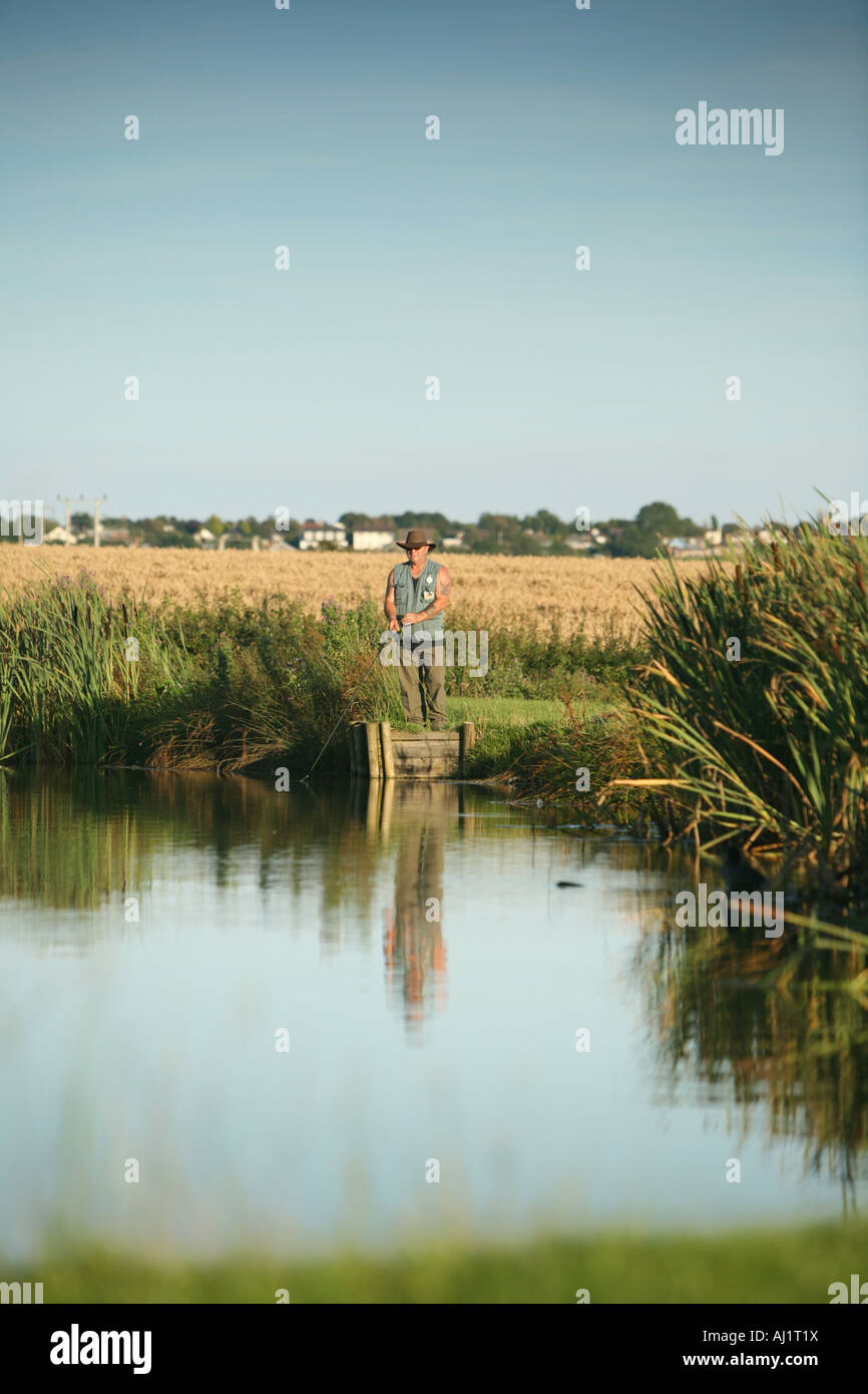 fly fishing on calm pond Stock Photo - Alamy