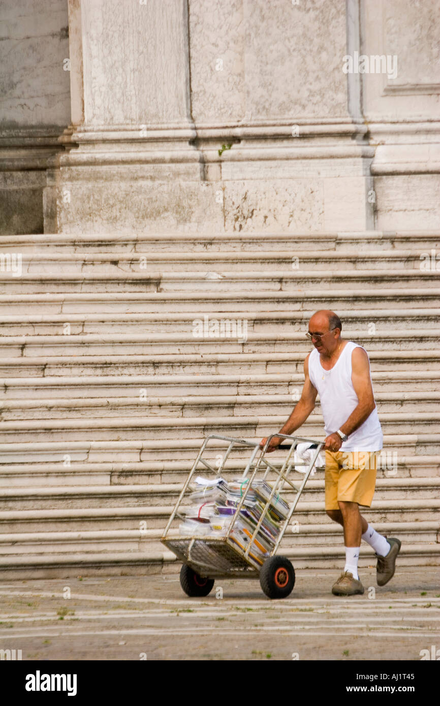 Man pushing cart filled with magazines Venice Italy Stock Photo - Alamy