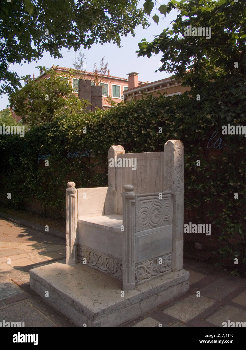 Carved stone chair in the outside garden of the Peggy Guggenheim ...