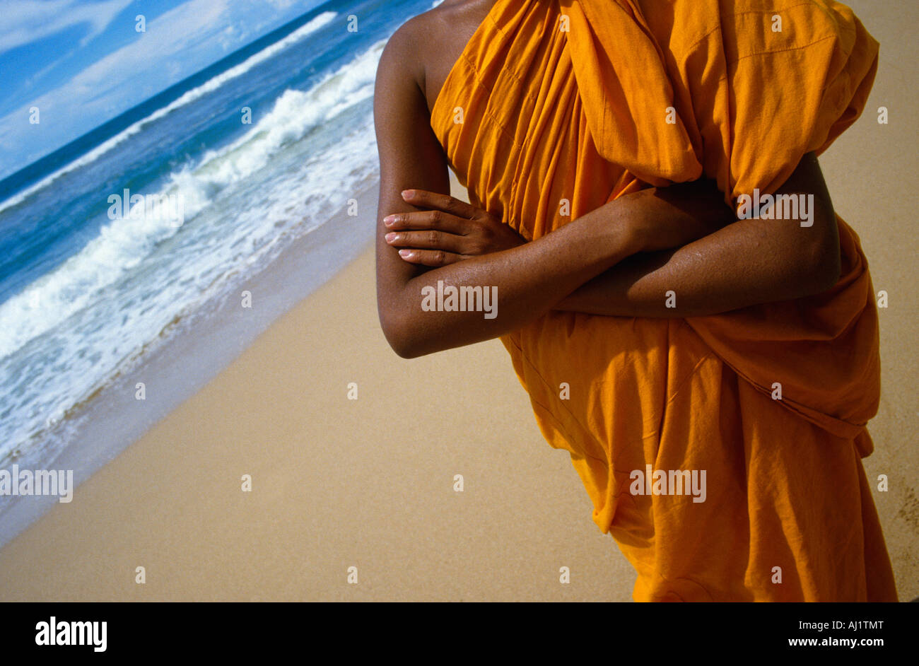 monk with arms folded against sea Stock Photo - Alamy
