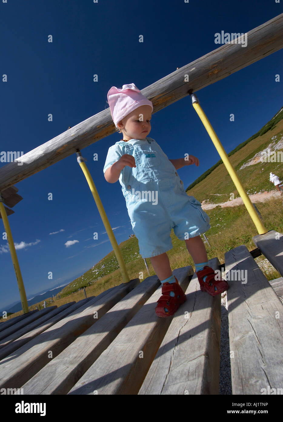 little child on plank bridge of a jungle gym Stock Photo - Alamy