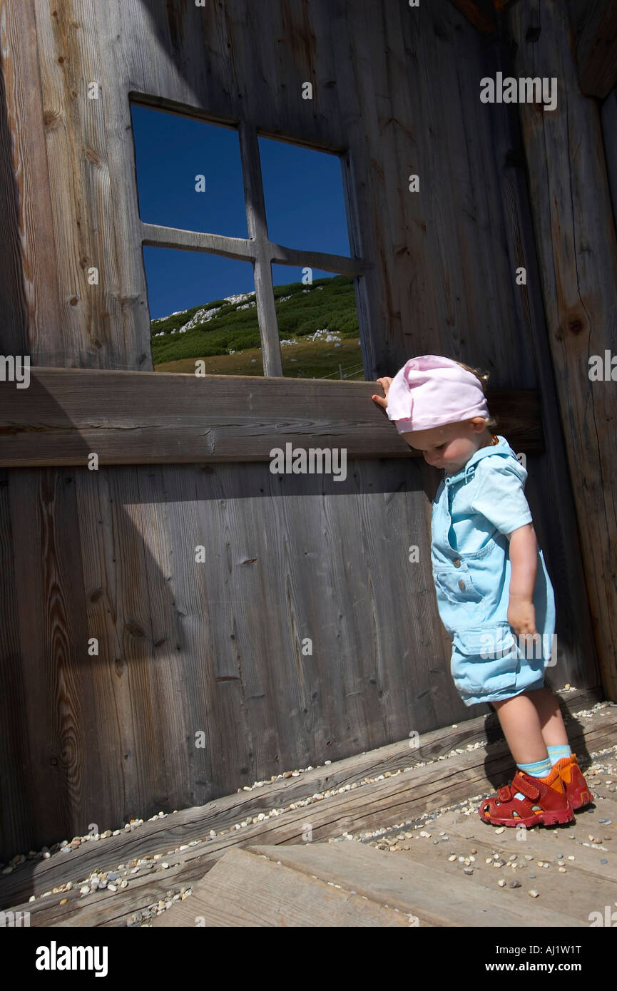 baby in wooden cabin with window Stock Photo - Alamy