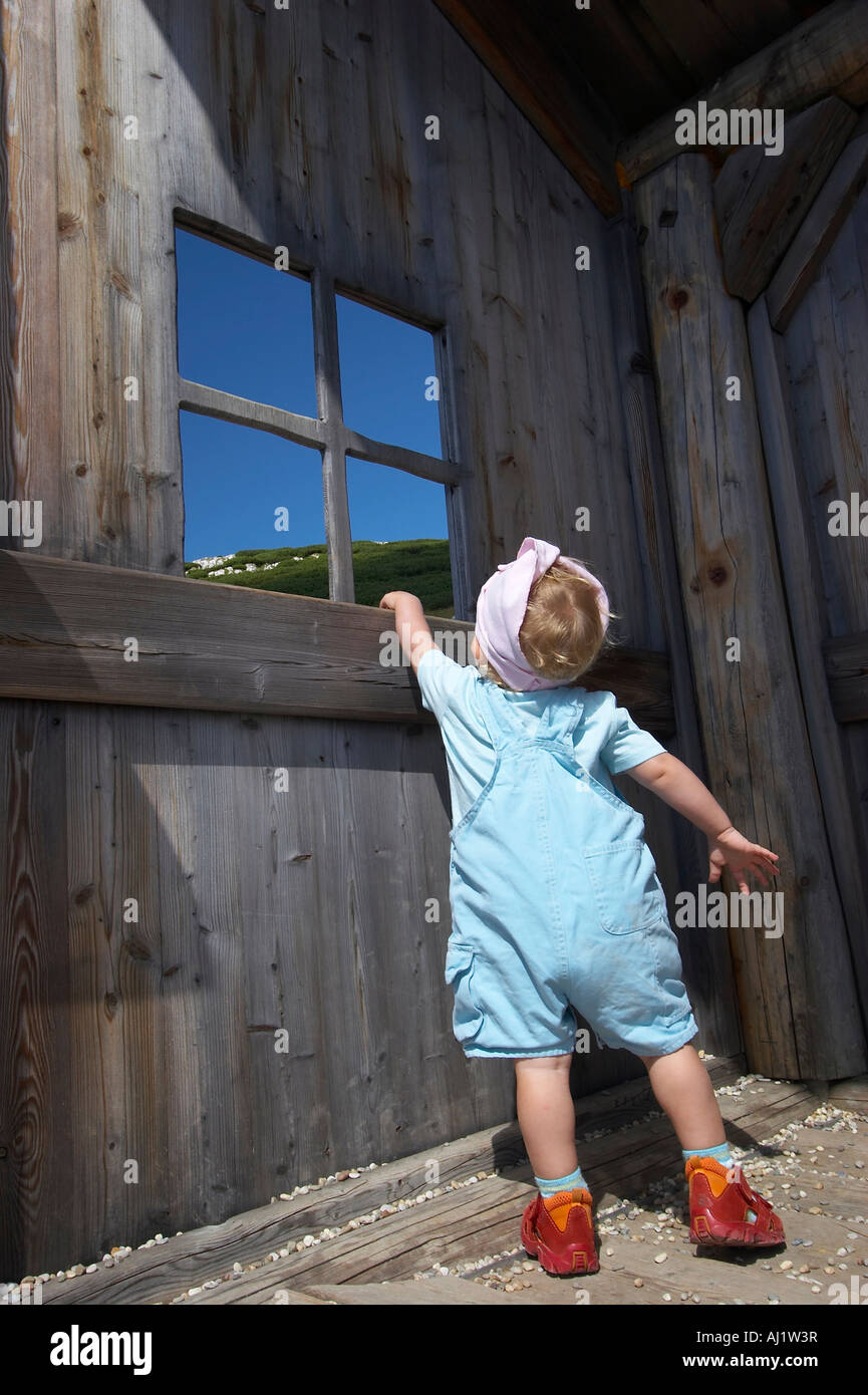 baby in wooden cabin with window Stock Photo - Alamy