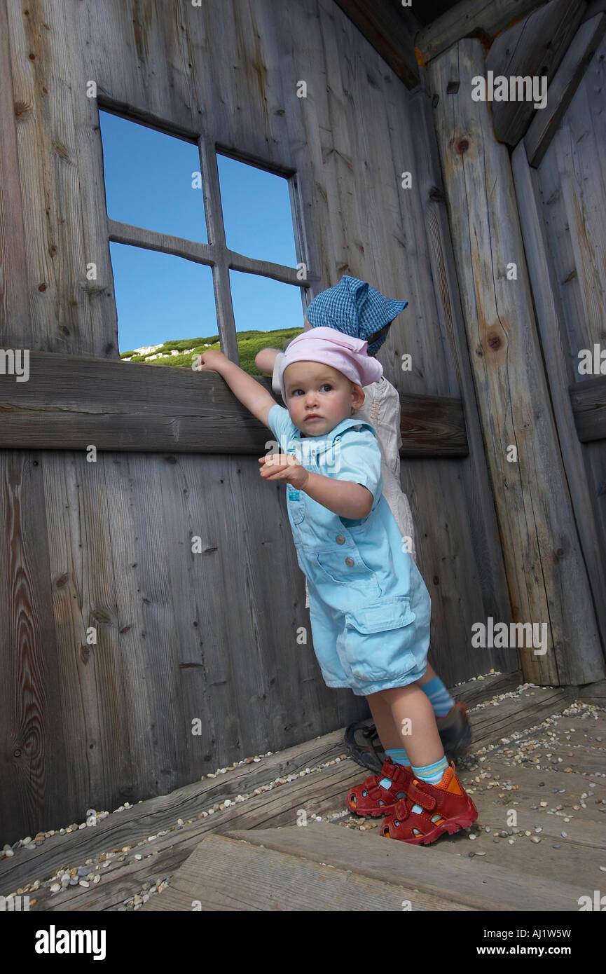 baby in wooden cabin with window Stock Photo - Alamy