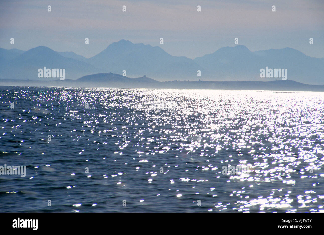 sparkling sea with mountains Stock Photo - Alamy