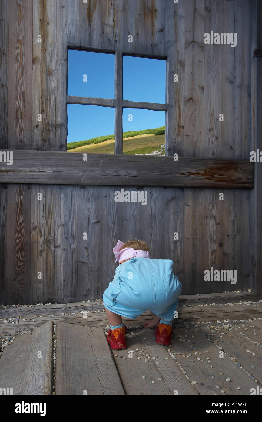 baby in wooden cabin with window Stock Photo - Alamy