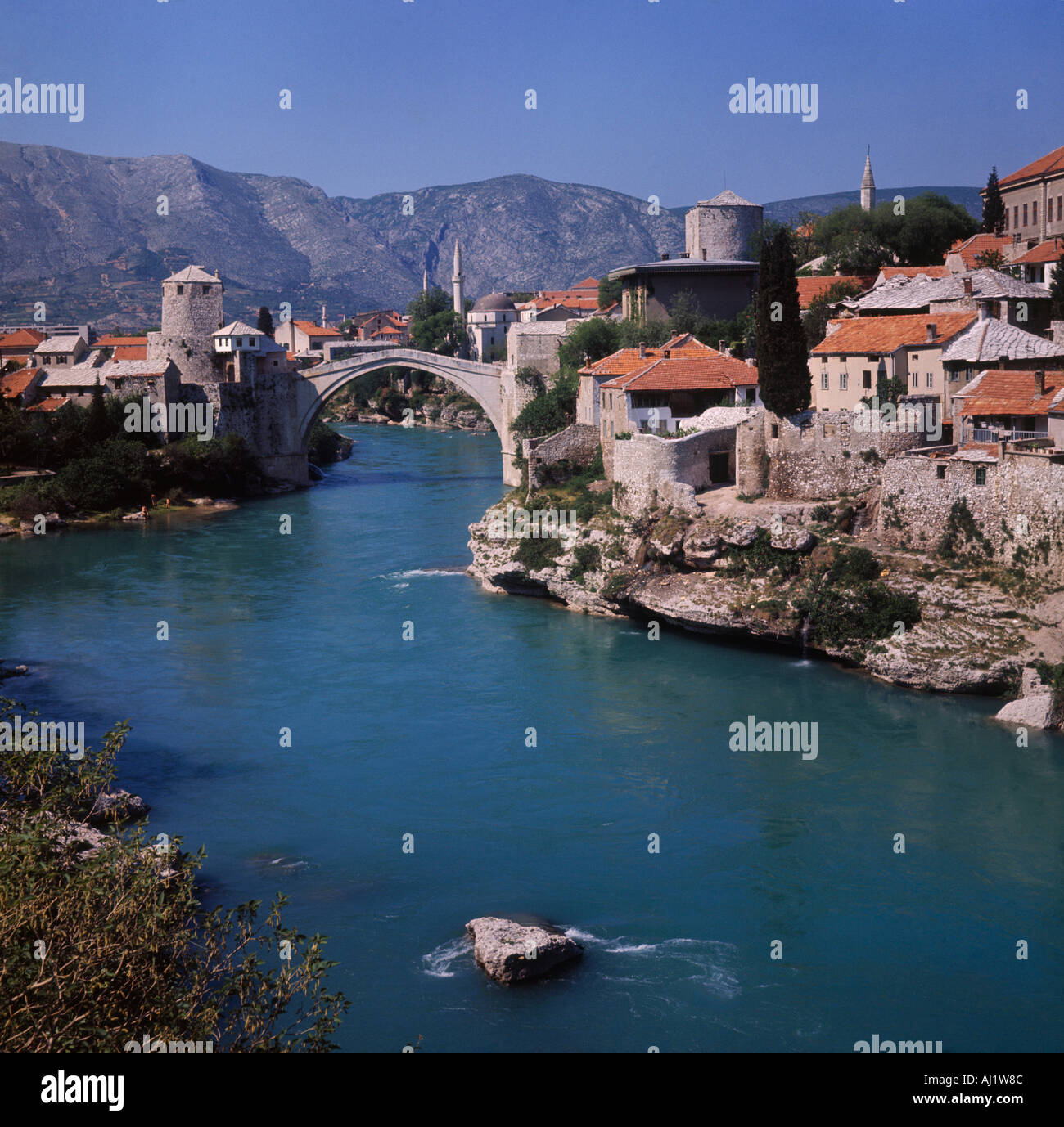 The classic original old arched stone built bridge with ancient watch ...
