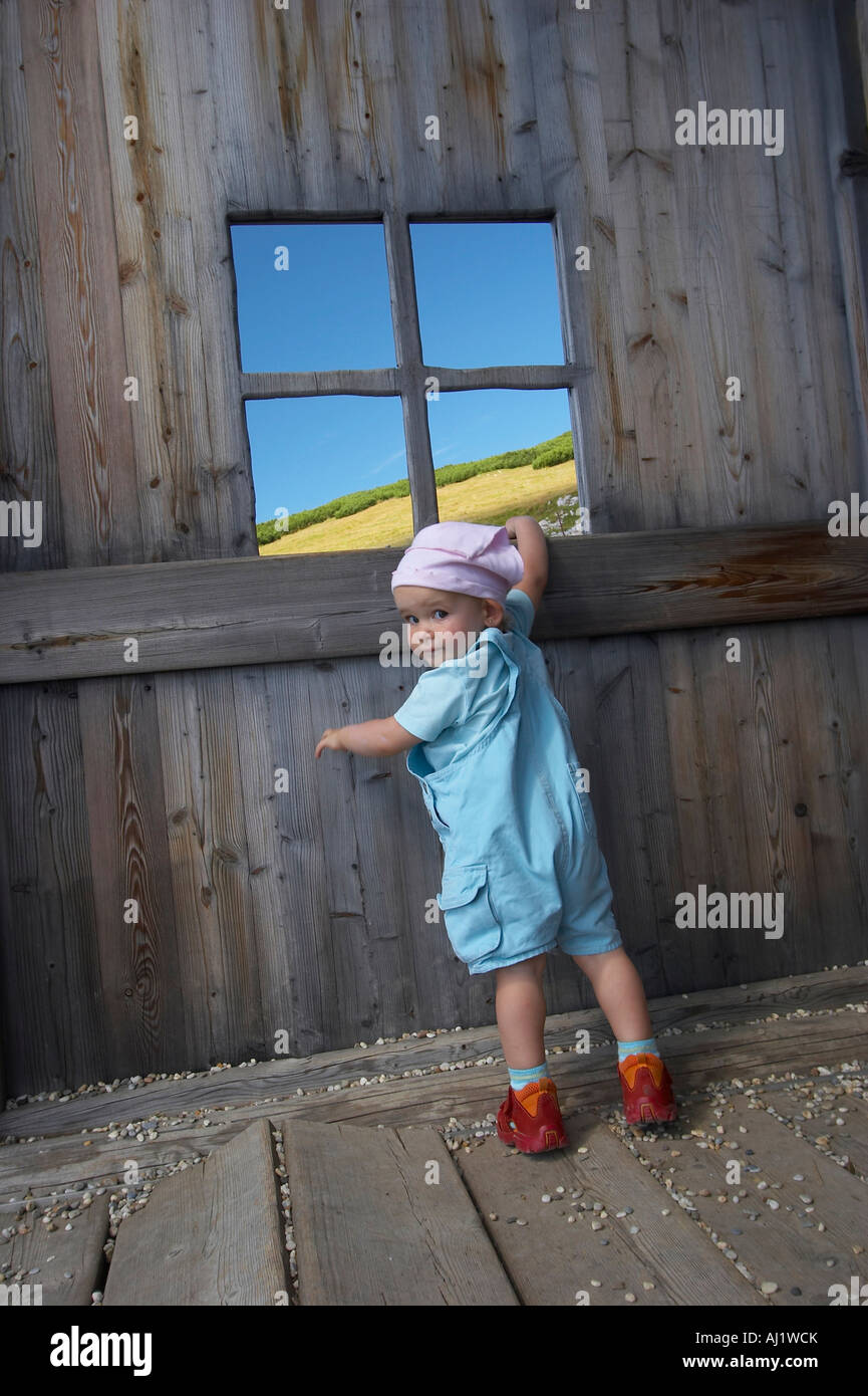 baby in wooden cabin with window Stock Photo - Alamy