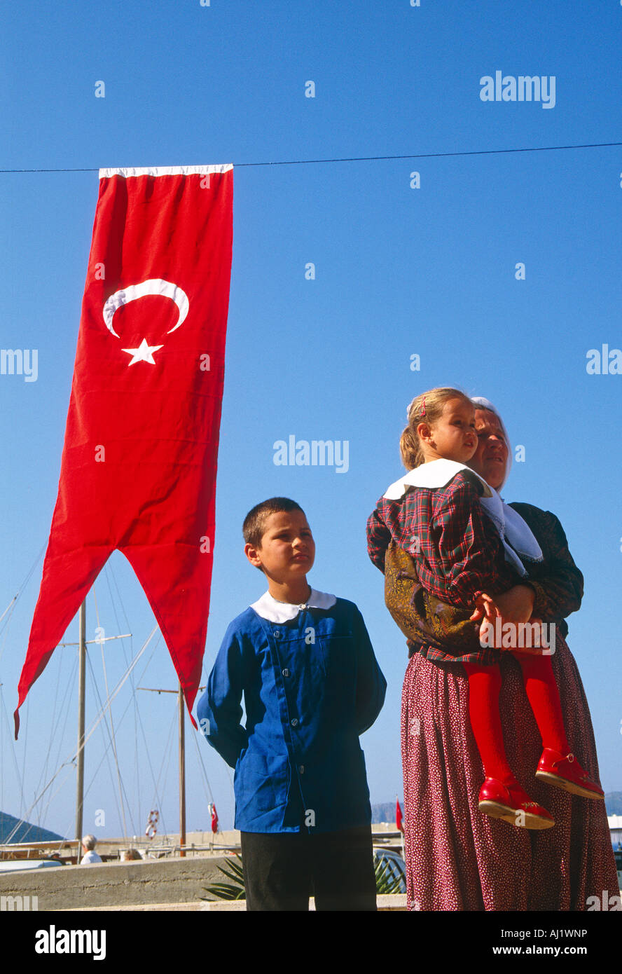 two Turkish children watch parade with grandmother Stock Photo - Alamy