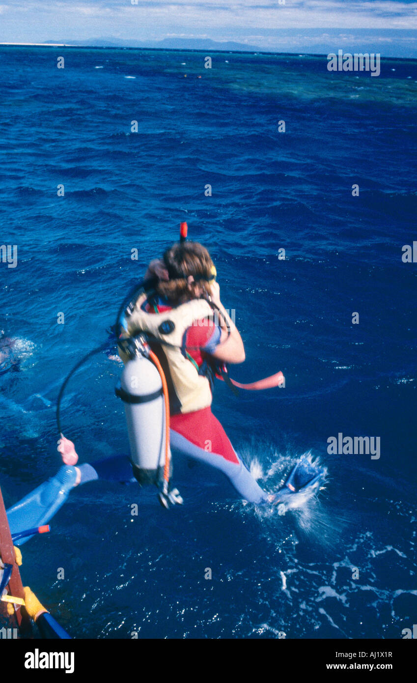 scuba diver jumping into sea Stock Photo - Alamy