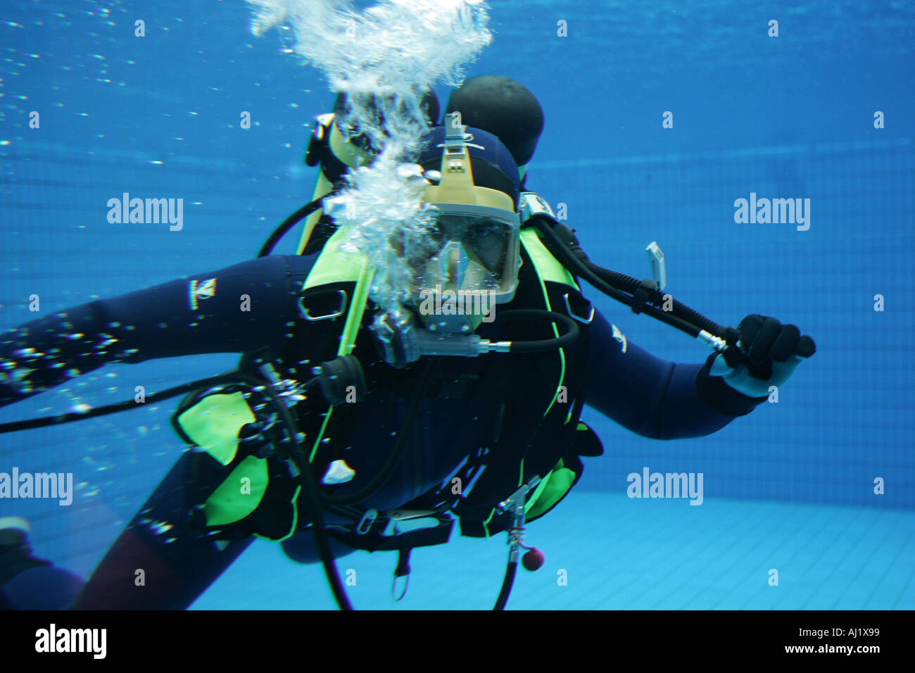 Rescue diver of a fire brigade at a training in a swimming pool in ...