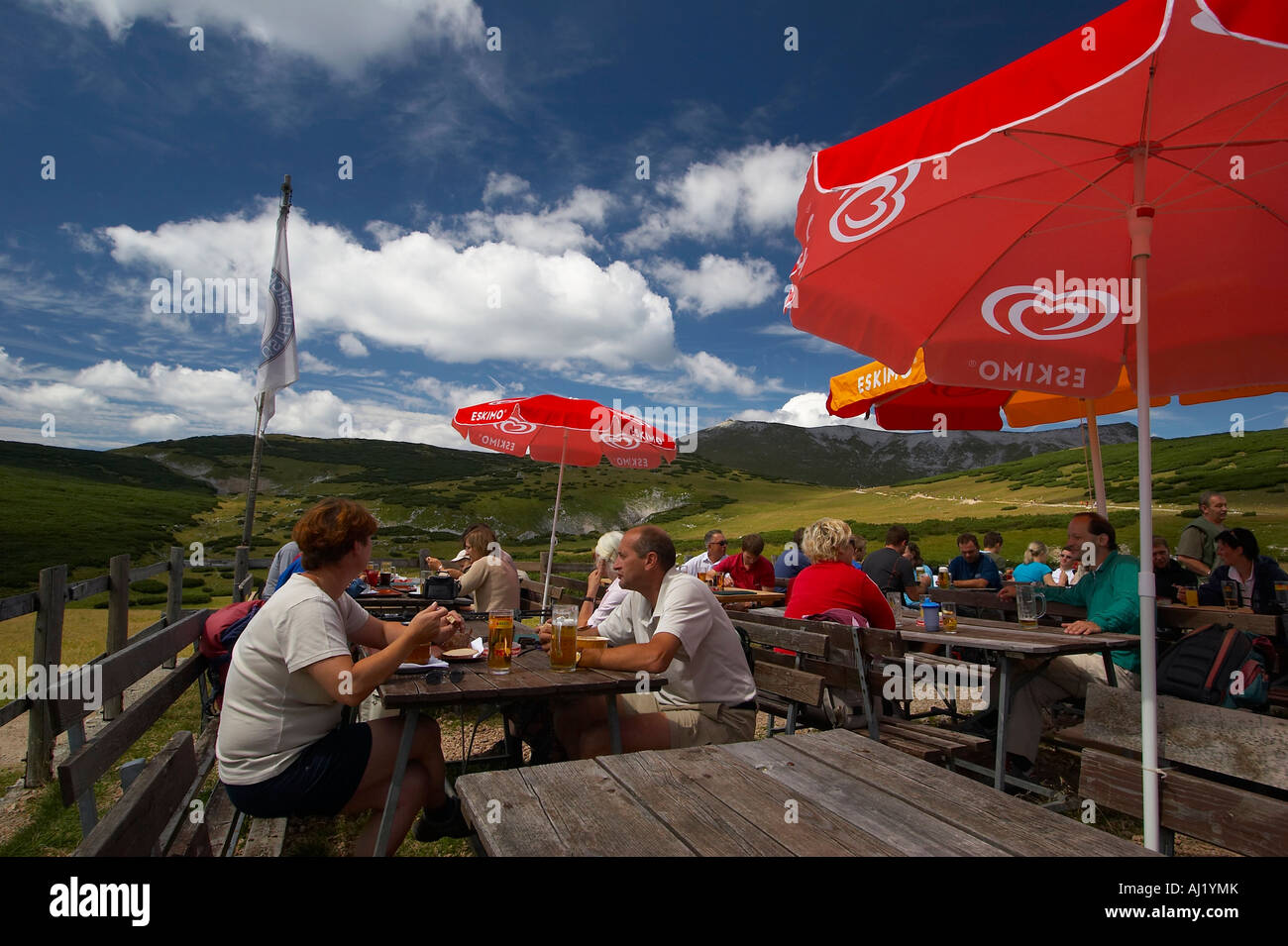tourists eating at alpine hut Stock Photo - Alamy