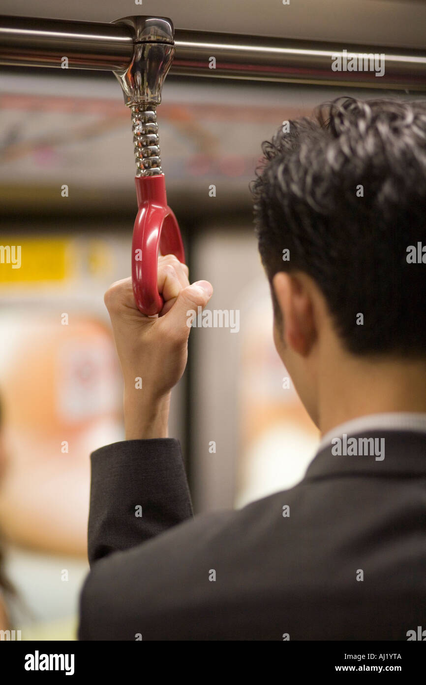 Hand holding strap on train hi-res stock photography and images - Alamy