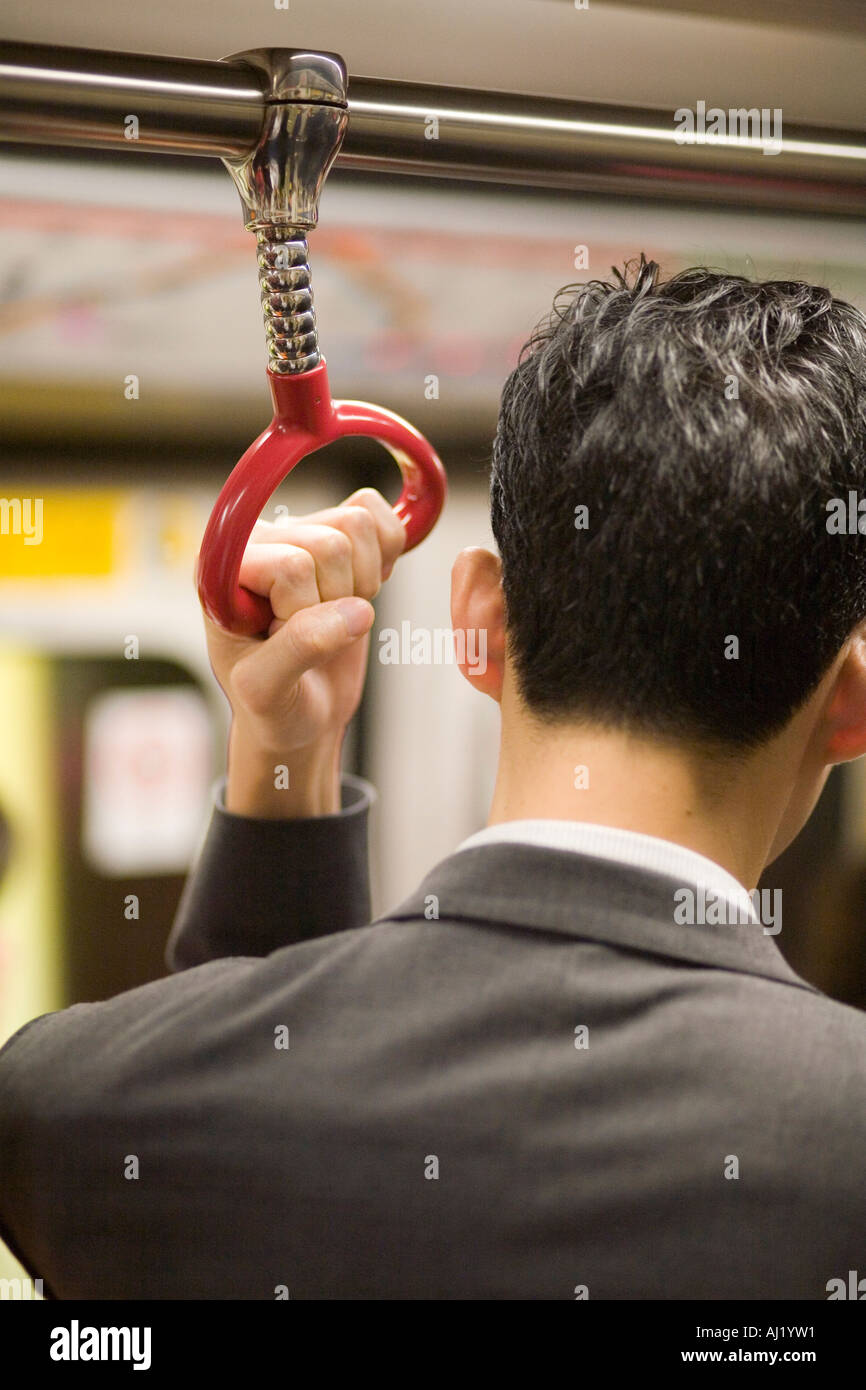 Hand holding strap on train hi-res stock photography and images - Alamy