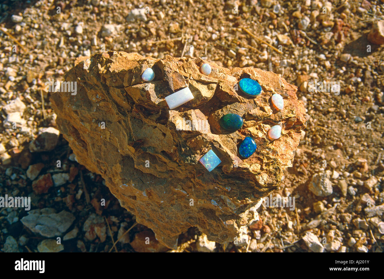 pieces of opal displayed on a rock Stock Photo - Alamy