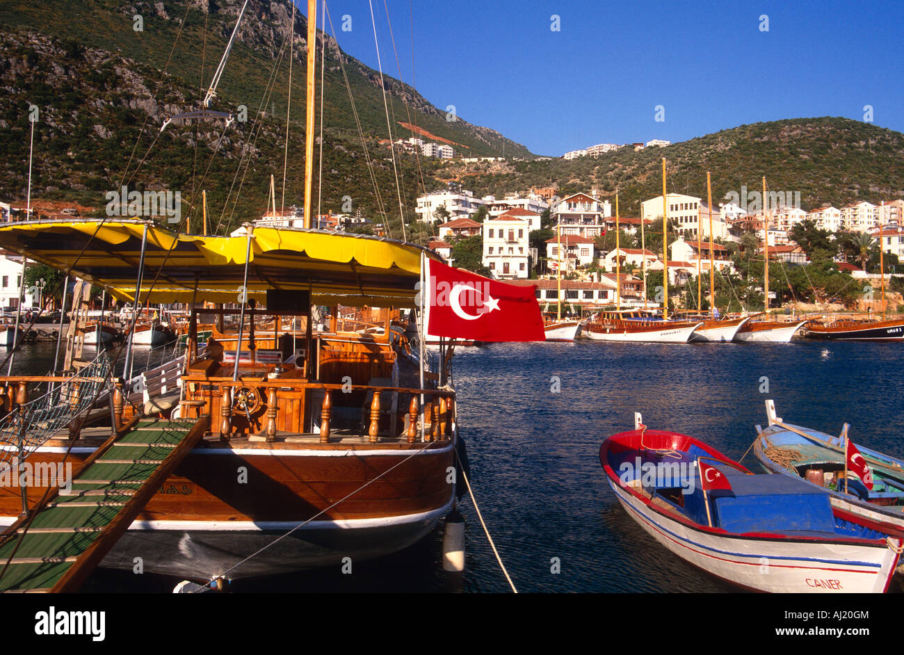fishing boats in harbour Turkey sunny late afternoon sun Turkish flag ...