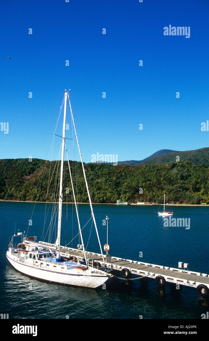 yacht moored at jetty in quiet rural inlet blue sky sunshine Stock ...