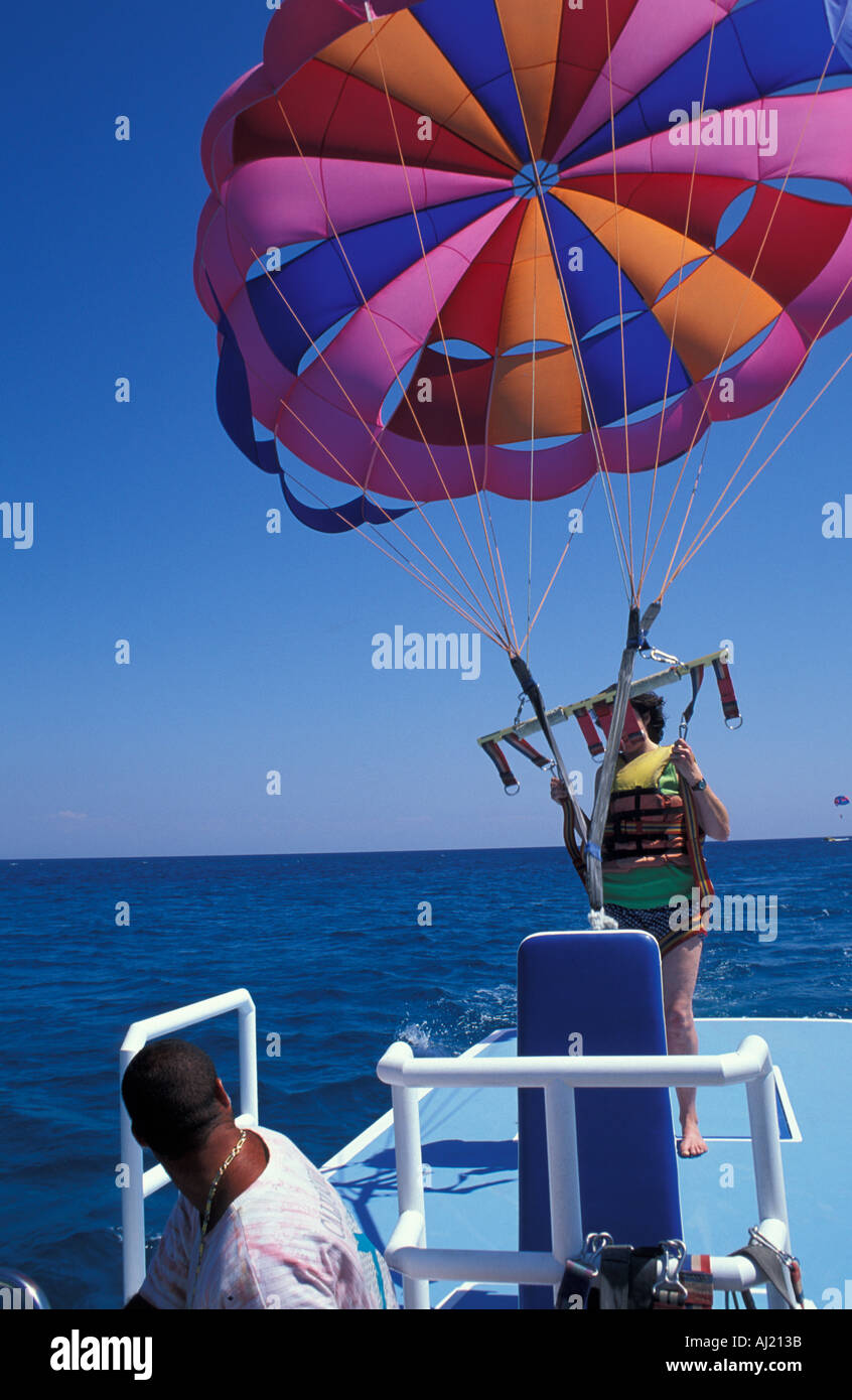 Woman preparing to take off from the boat parasending Caribbean Stock ...