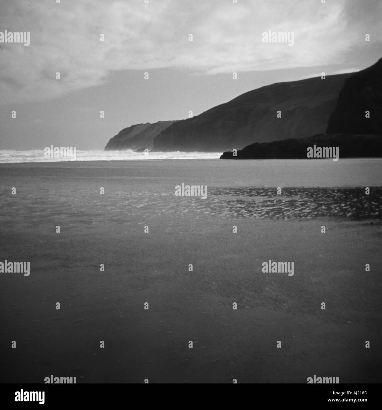 beach and its coast line shot from the beach lots of waves coming in ...