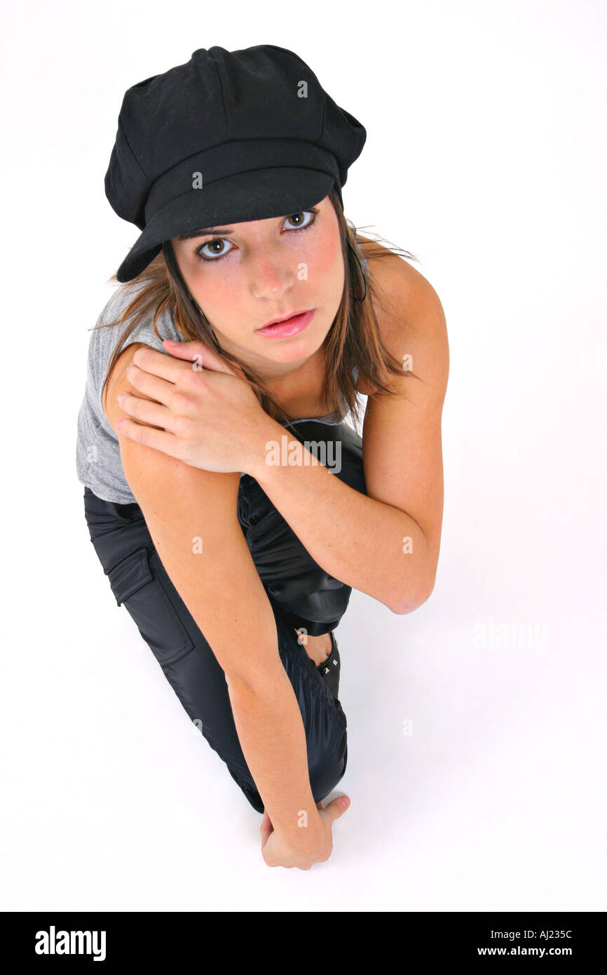 Young black haired woman with hat gray t shirt and satin pants ...
