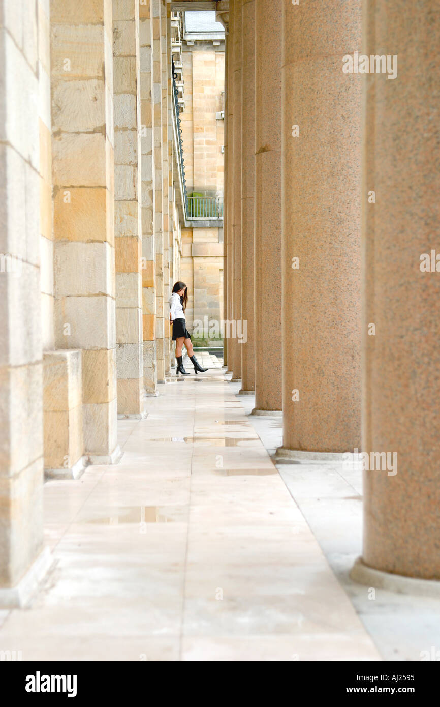 Long corridor with columns schoolgirl on the far end Stock Photo - Alamy